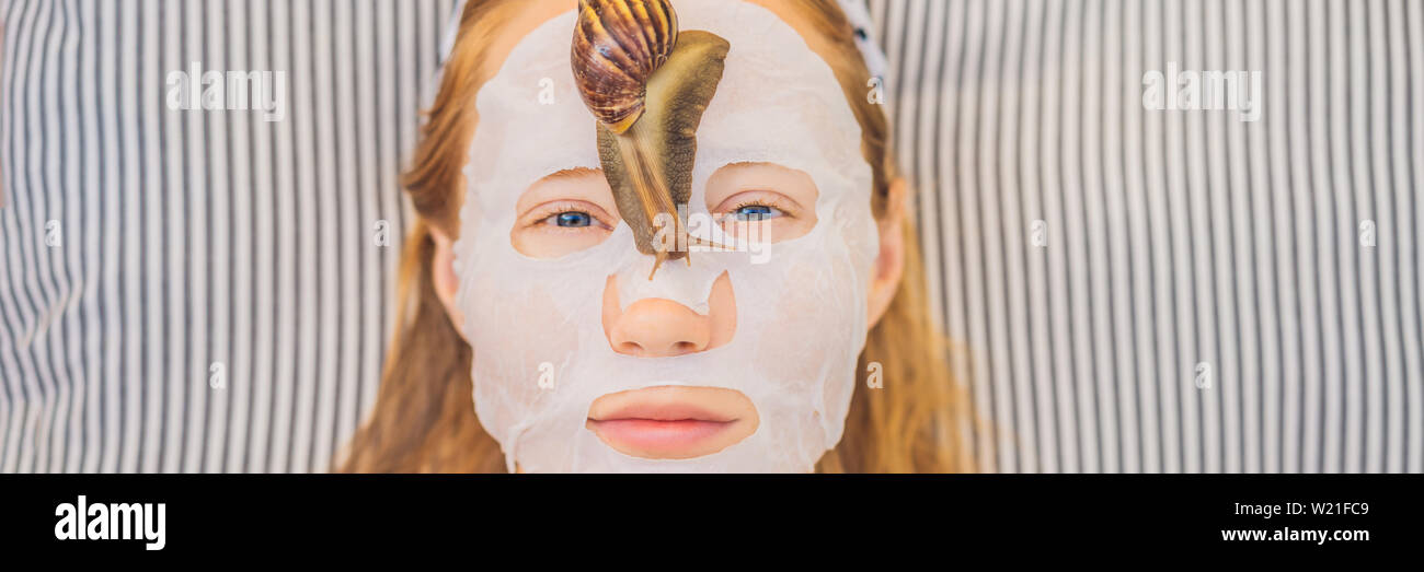 Young woman makes a face mask with snail mucus. Snail crawling on a ...