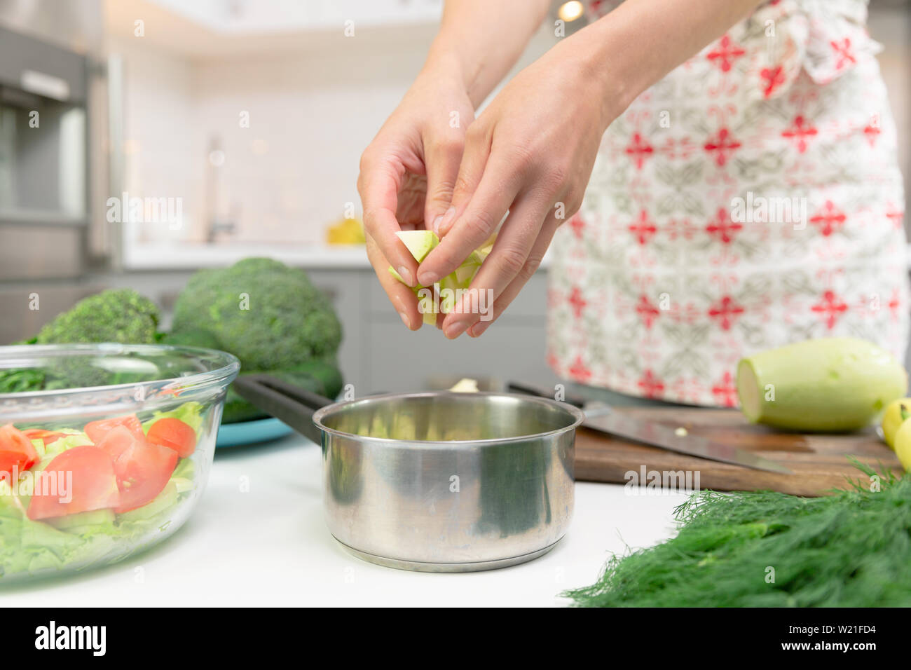 Woman preparing delicious and healthy food in the home kitchen. Healthy ...