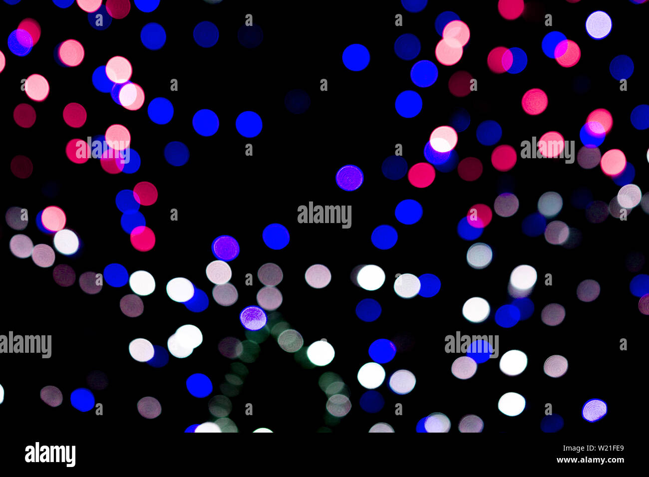 Unfocused abstract colourful bokeh on black background. defocused and ...