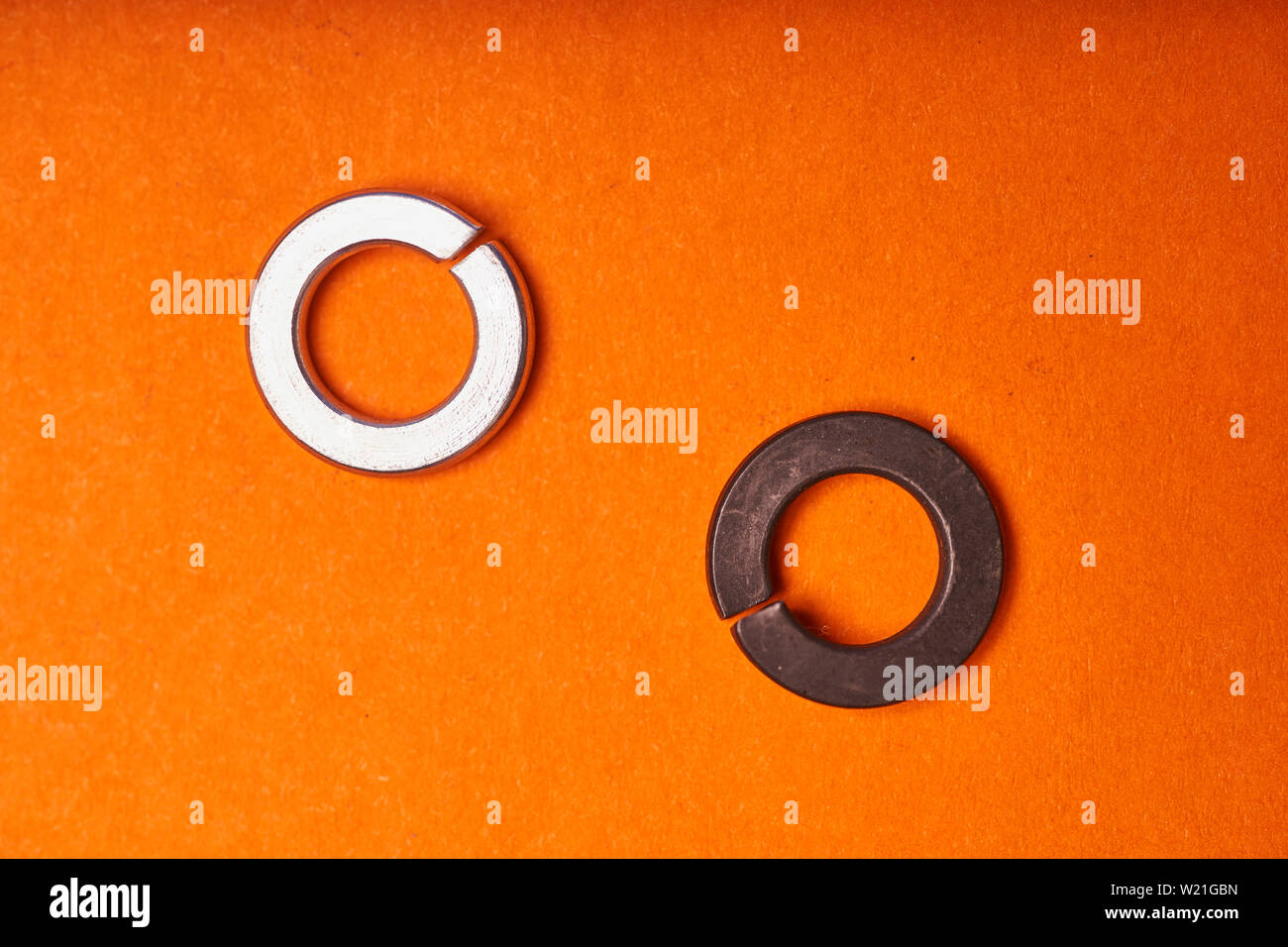 spring washers on orange background. Bolted connection elements Stock ...