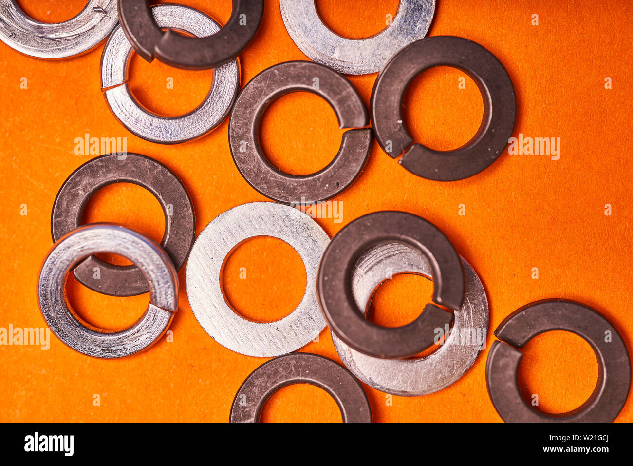 spring washers on orange background. Bolted connection elements Stock ...