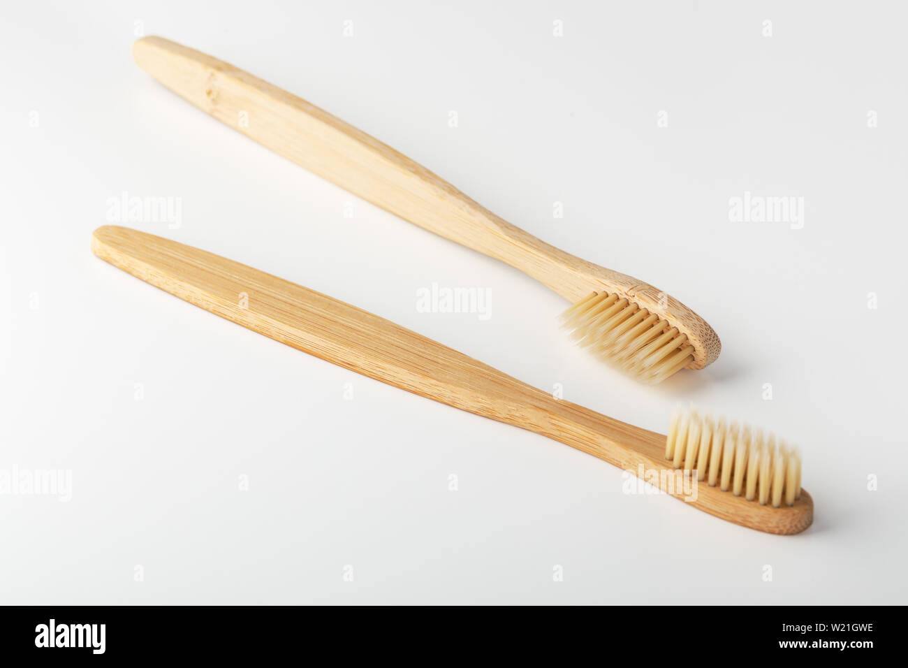 Wooden toothbrushes on white background Stock Photo - Alamy