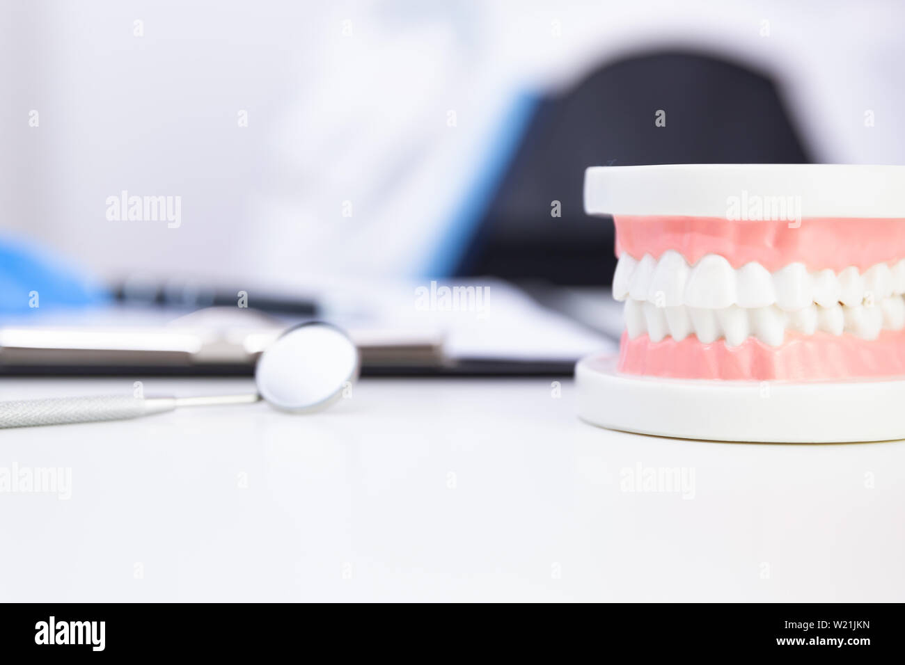 Orthodontic teeth model and professional dentist tools on the table in ...