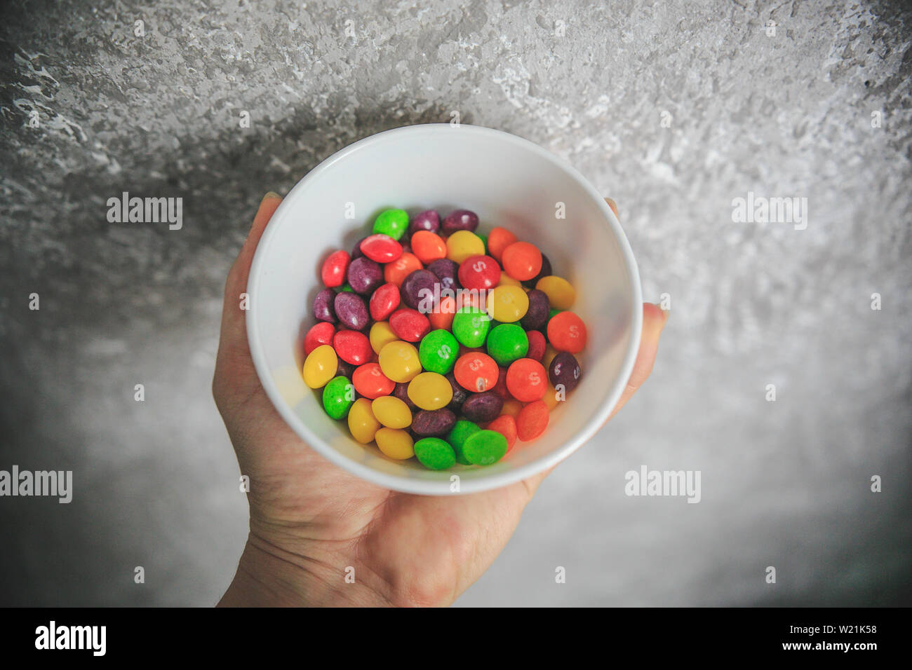 MOSCOW, RUSSIA - JULY 5, 2019: Colorful skittles candies on gray and ...