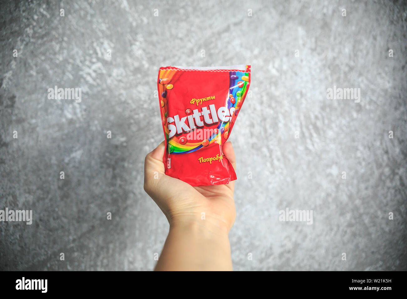 MOSCOW, RUSSIA - JULY 5, 2019: Colorful skittles candies on gray and ...
