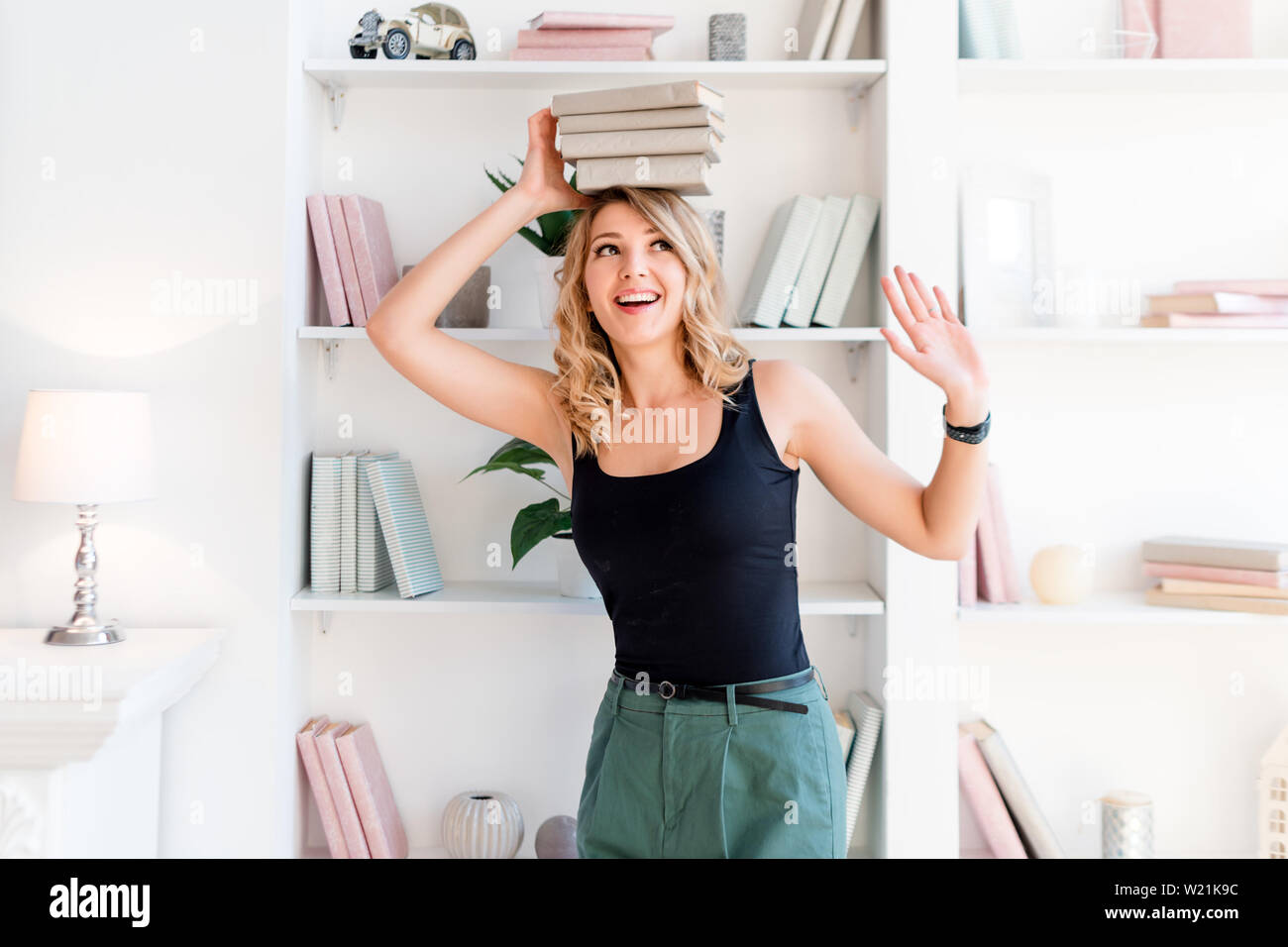 Woman balancing books head hi-res stock photography and images - Alamy