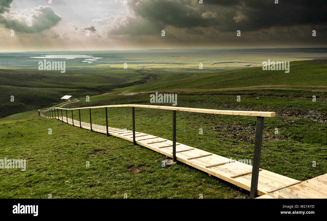 Wooden platform on a high hill in the steppes of Kalmykia. Spring ...