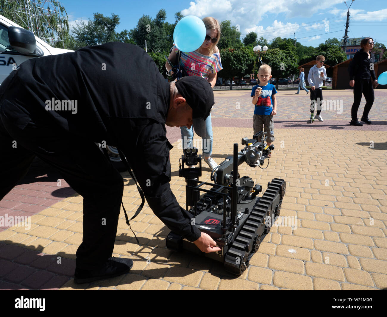 A woman with her grandson watching the demonstration of the robot used ...