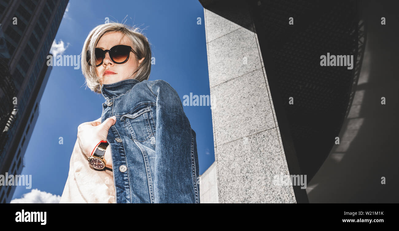 Portrait against the sky blonde with short hair. The concept of modern ...