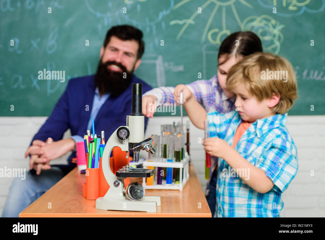 students doing science experiments with microscope in lab. back to ...