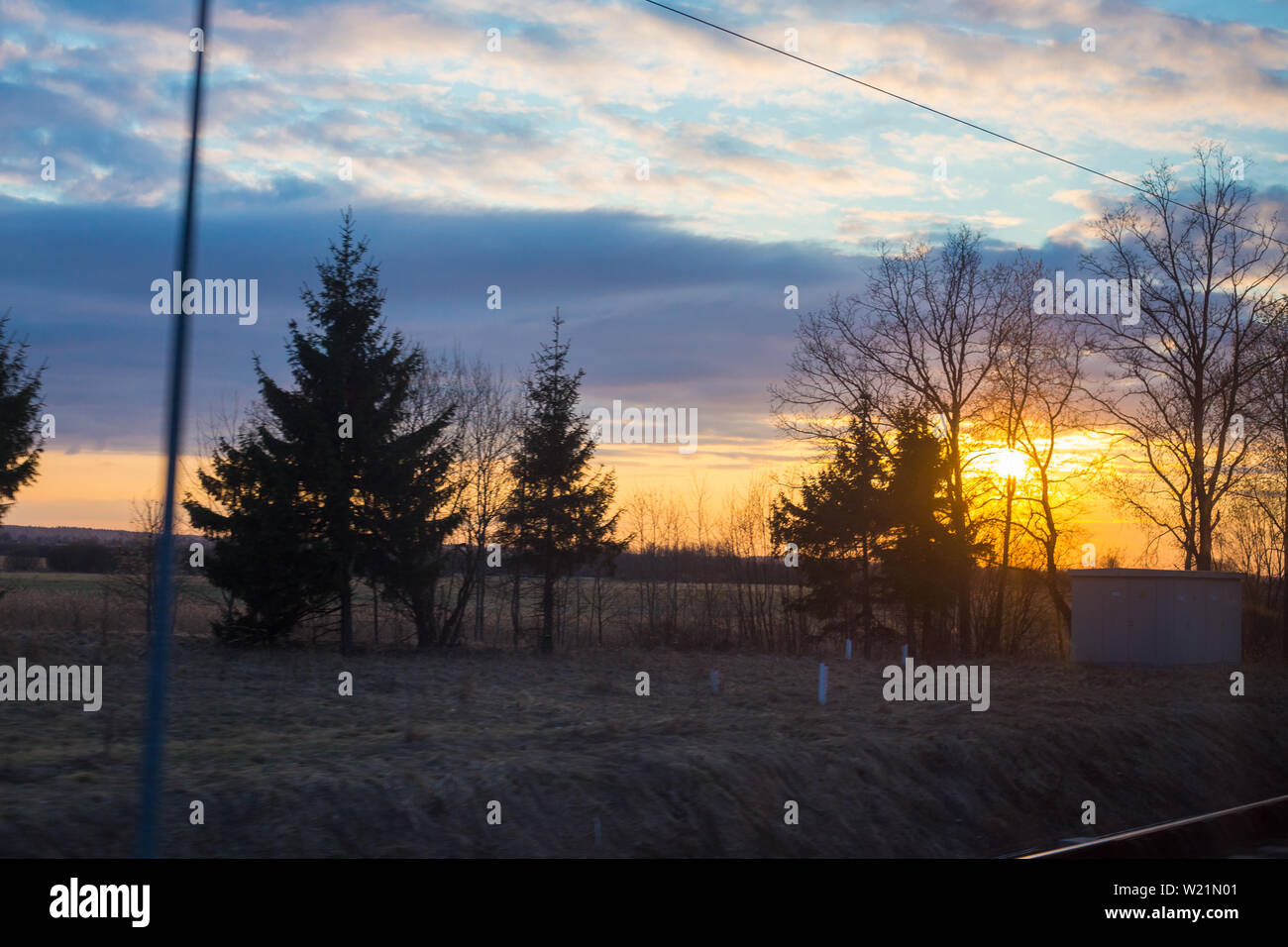 Train window view with dramatic sunset light Stock Photo - Alamy