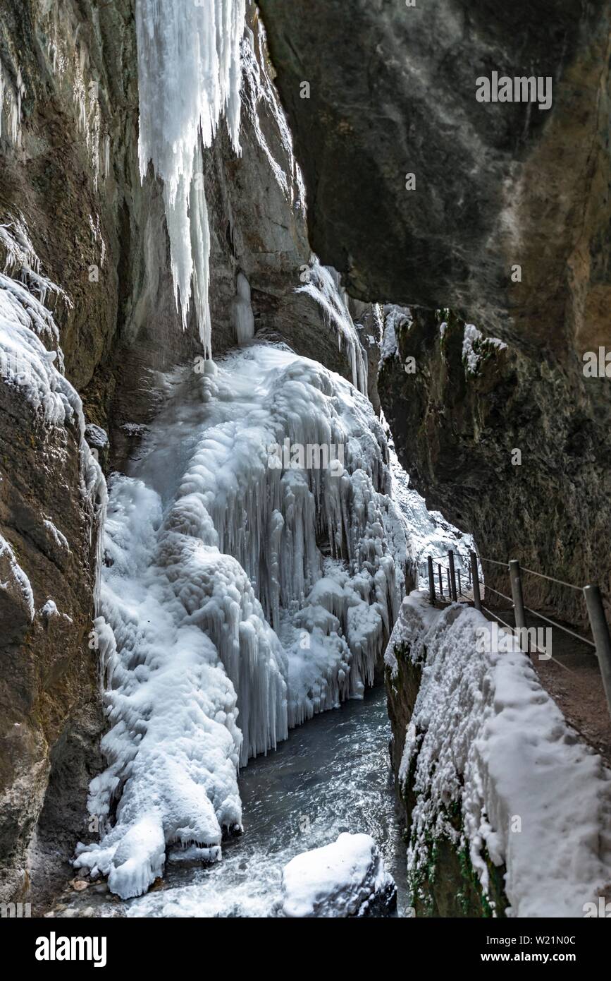 Path to Partnach wild river in the Partnach gorge with long icicles and ...