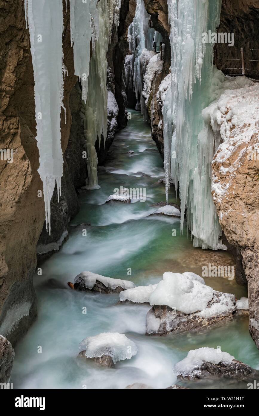 Path to Partnach wild river in the Partnach gorge with long icicles and ...