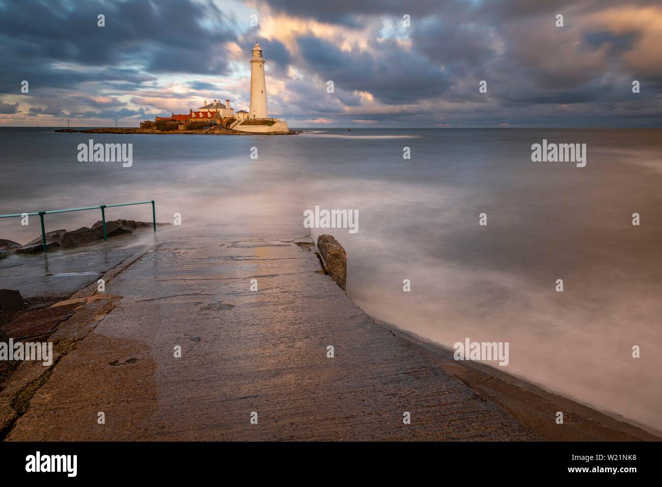 Lighthouse, St. Mary's Lighthouse with washed over road at high tide ...