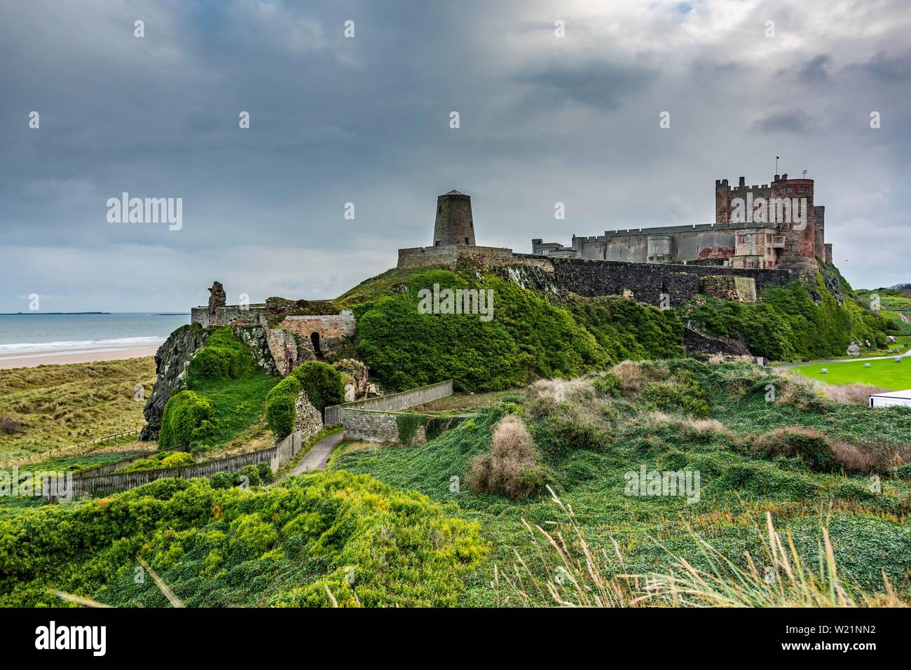 Dune landscape with Bamburgh Castle under a cloudy sky, Bamburgh, New ...