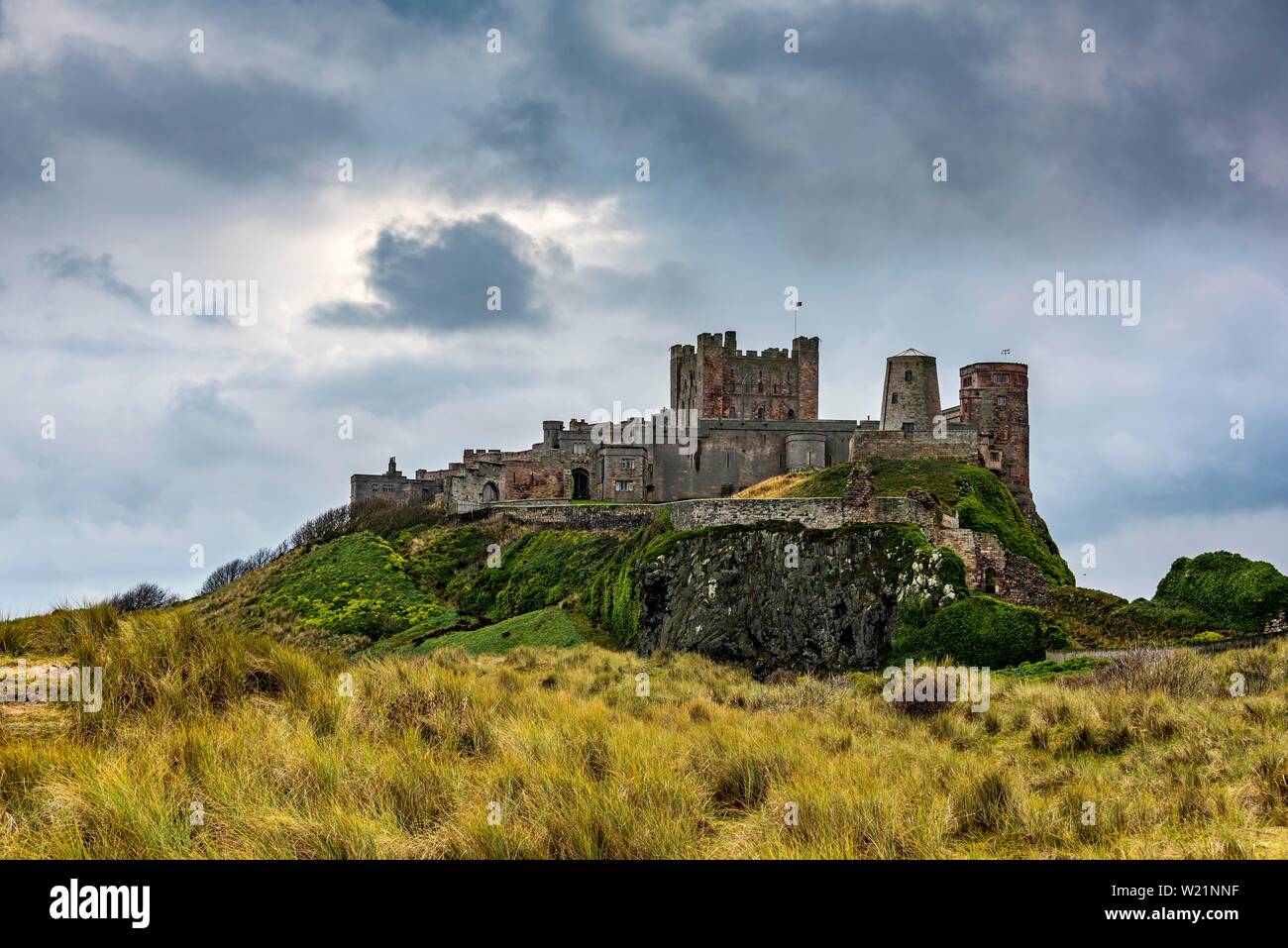 Dune landscape with Bamburgh Castle under a cloudy sky, Bamburgh, New ...