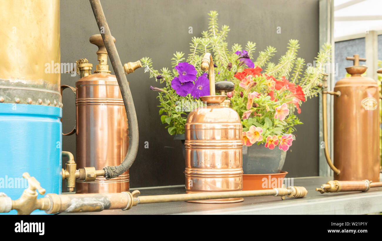 Garden and gardening: old copper tools, old sprayers Stock Photo - Alamy