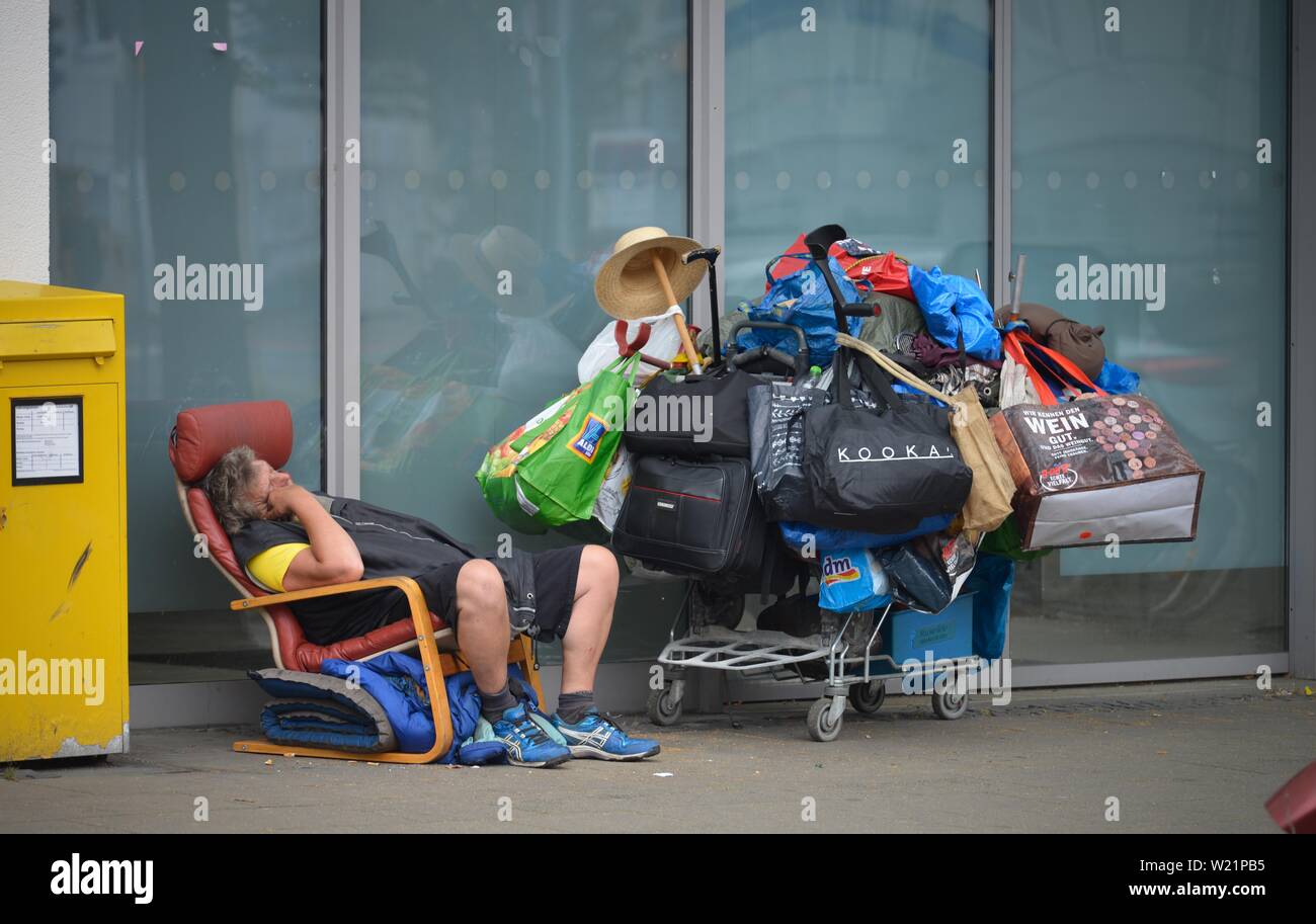 Homeless person with many bags on luggage trolley hi-res stock ...