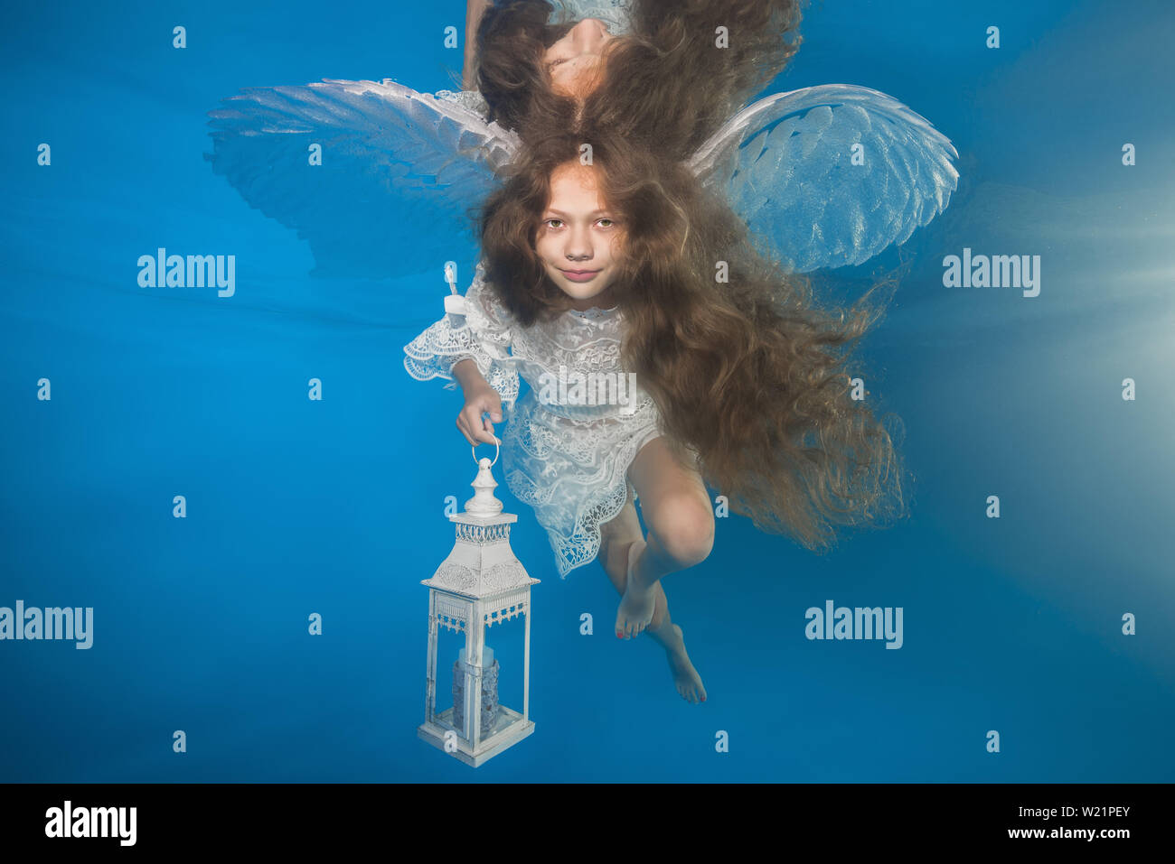 Clothed woman floating or underwater hi-res stock photography and ...