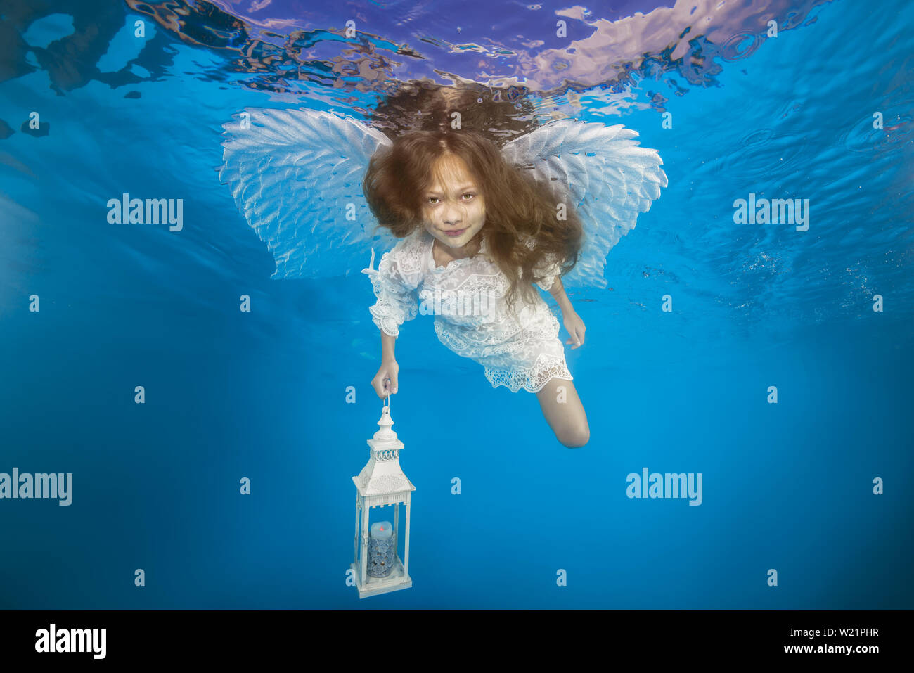 Clothed woman floating or underwater hi-res stock photography and ...