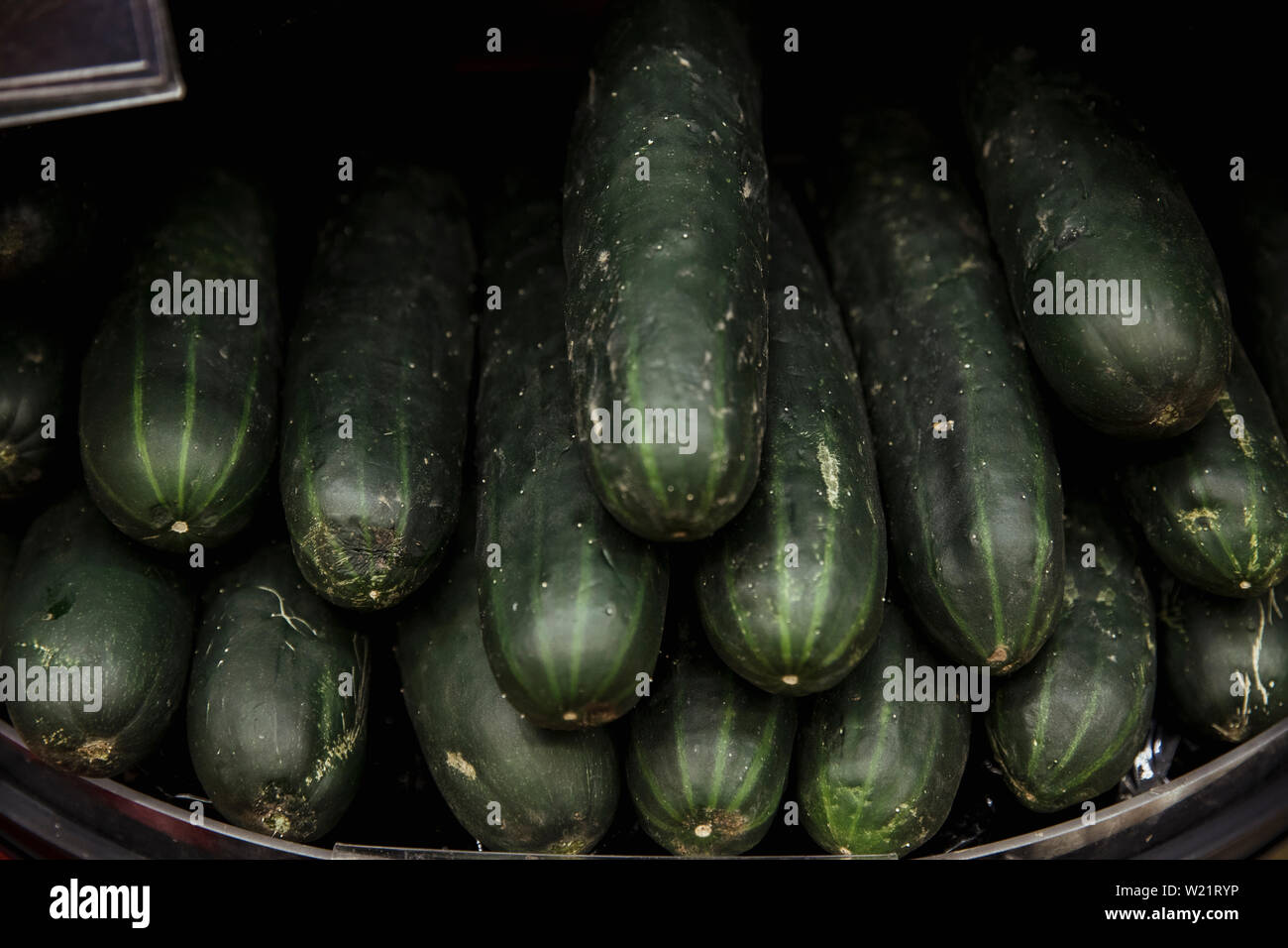 A close-up shot of an abundance of fresh courgette's on display at a ...