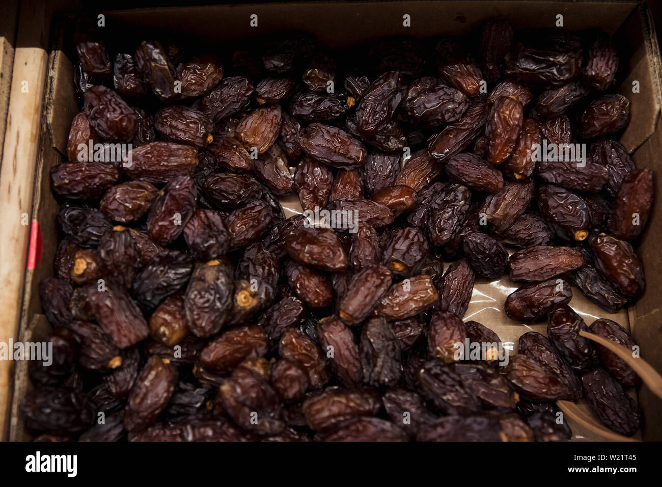 A close-up shot of an abundance of fresh Dates on display at a market ...
