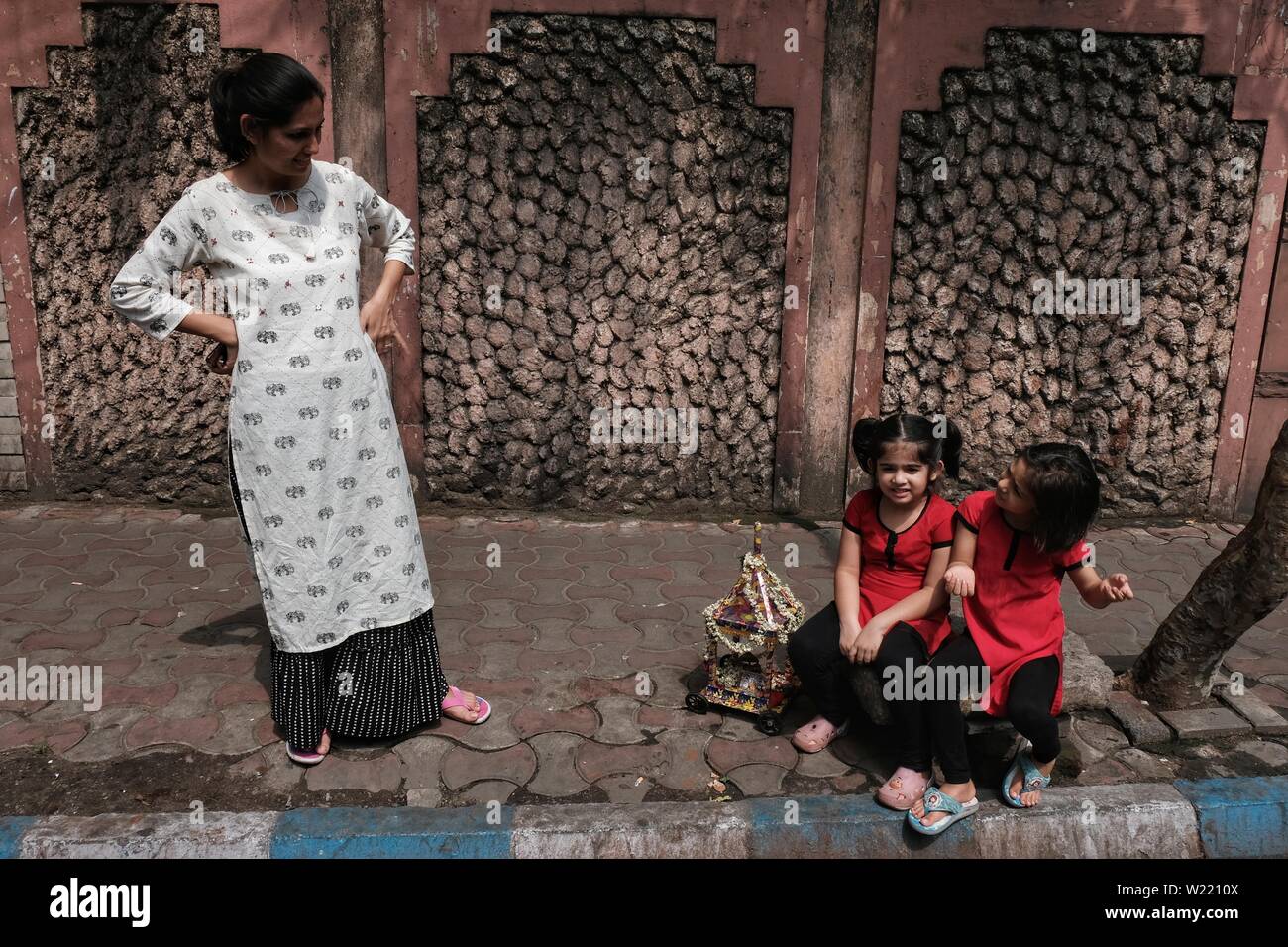 Kids love to pull small Chariot. Here two kids are sitting beside the ...