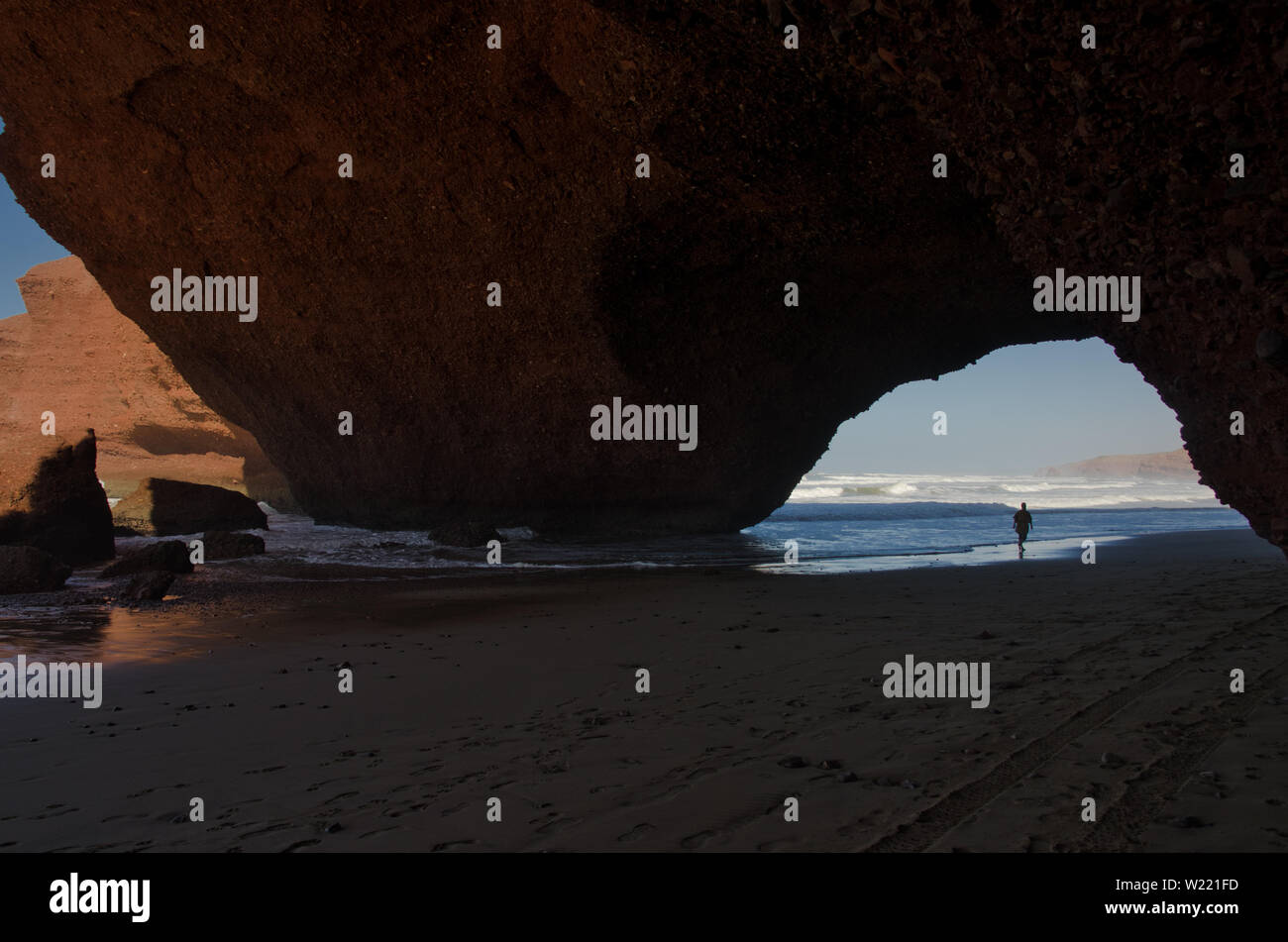 Red rock formation with arch on the beach, Plage Sidi Ifni, Morocco ...