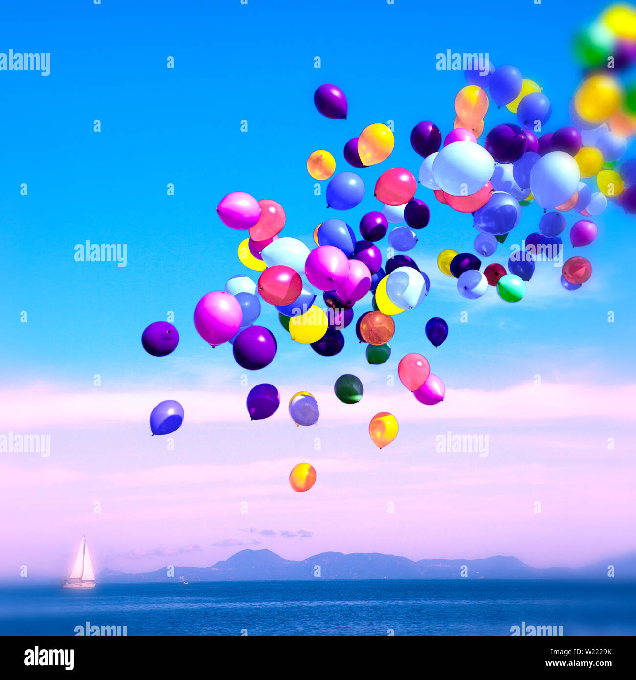 Colorful balloons drifting over the calm blue sea. on the background of ...