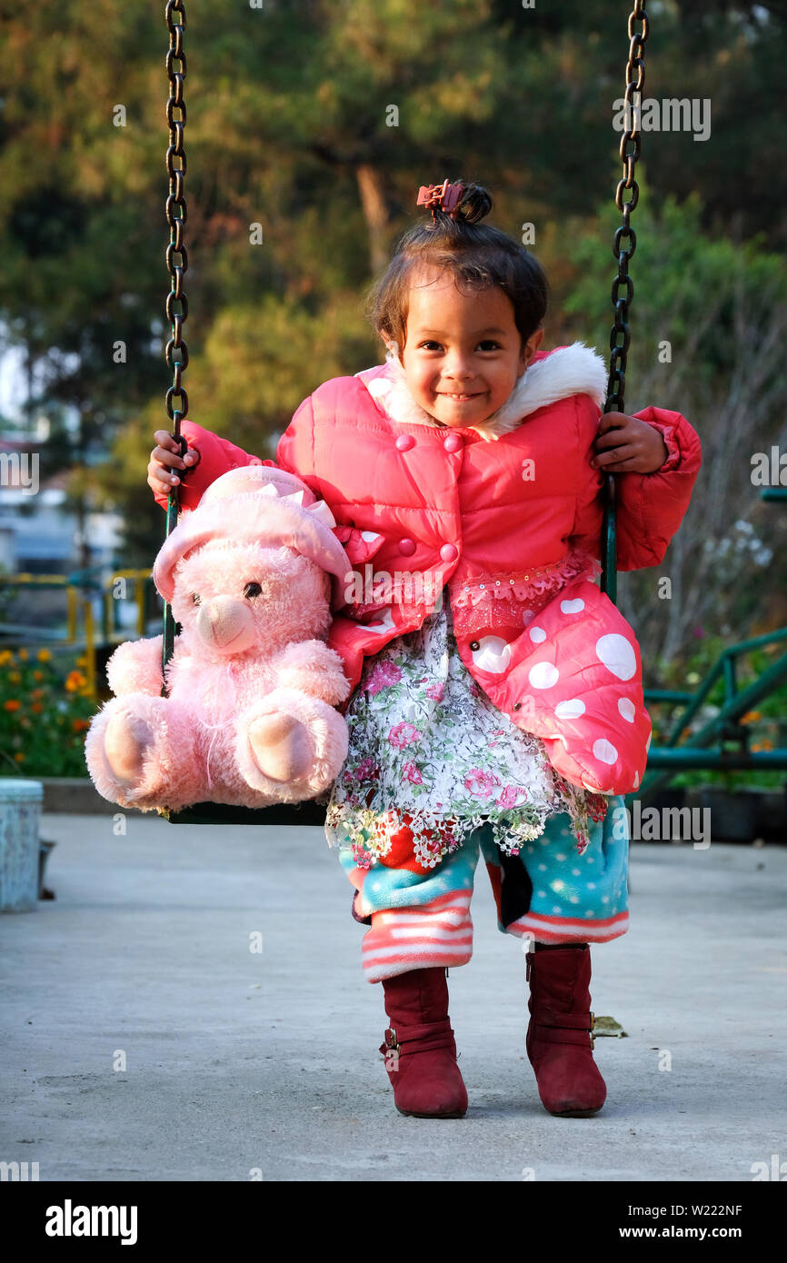 Girl (3 1/2 years old) swings with her giant teddy at the "Ferrando ...