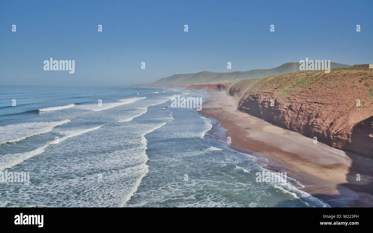 Red rock formation with arch on the beach, Plage Sidi Ifni, Morocco ...