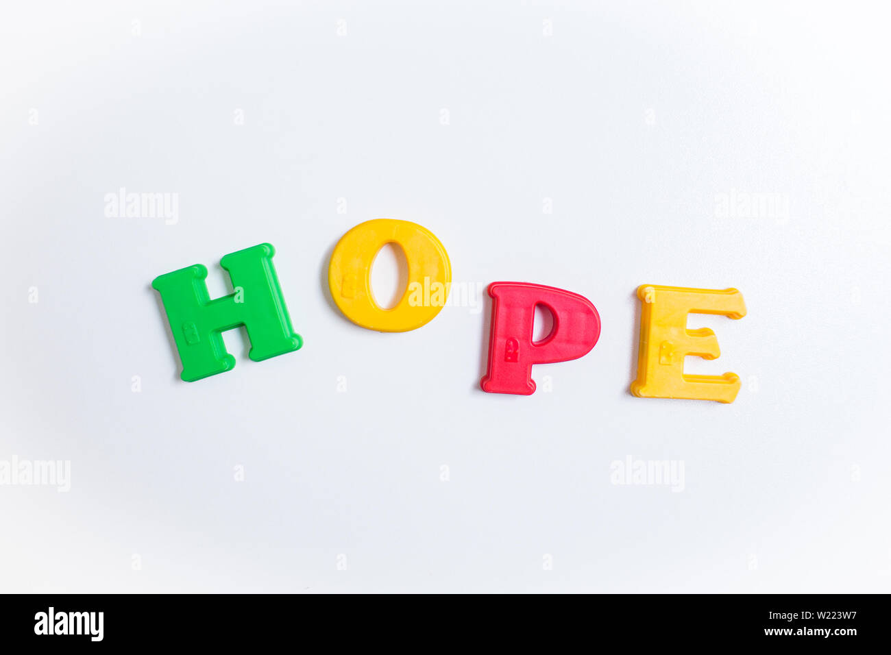 The word HOPE with multicolor kids letters on a pure white background ...