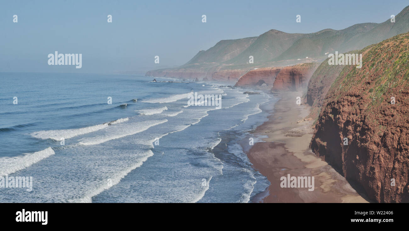 Red rock formation with arch on the beach, Plage Sidi Ifni, Morocco ...