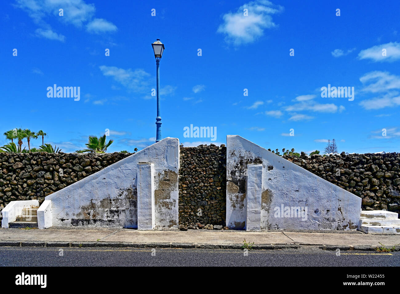 Lanzarote pyramid stairs lamp post with blue skies and palm trees Stock ...