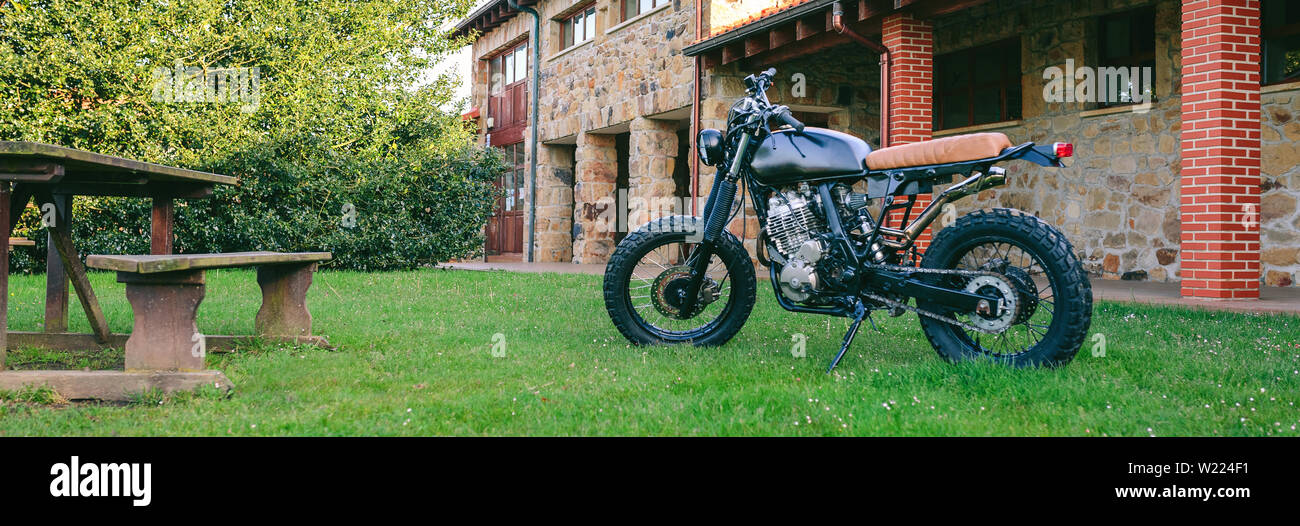 Custom motorcycle parked on the grass Stock Photo - Alamy