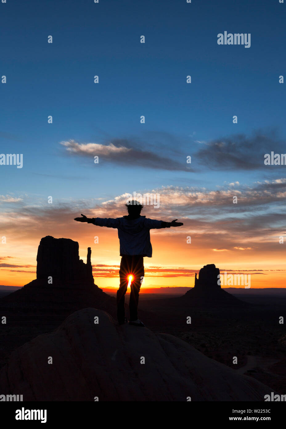 Open arms sunset over East and West Mitten Buttes, Monument Valley ...