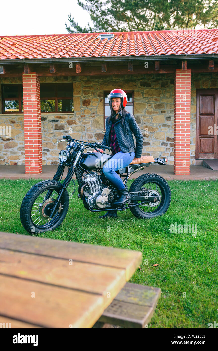 Woman with helmet riding custom motorbike Stock Photo - Alamy
