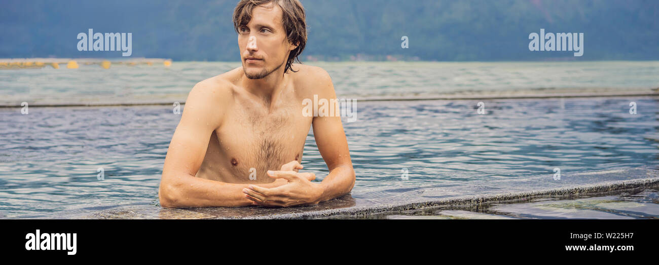 Geothermal spa. Man relaxing in hot spring pool. Young man enjoying ...