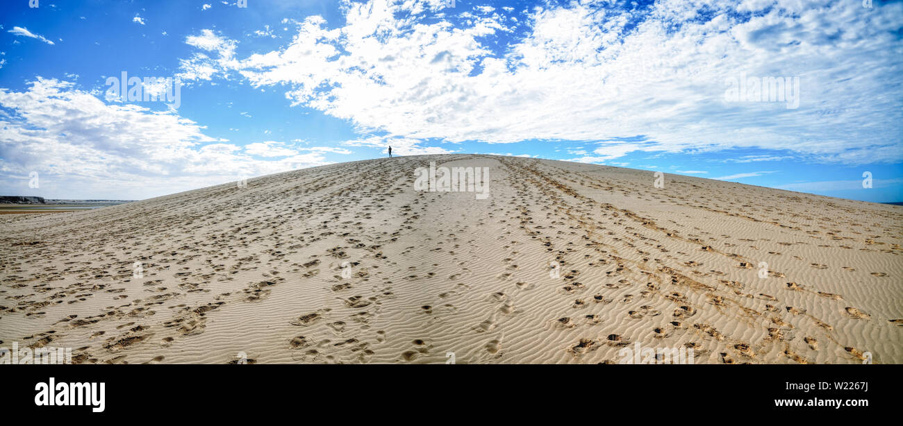 Scenic panorama of sand dunes and the Atlantic ocean with cloudy blue ...