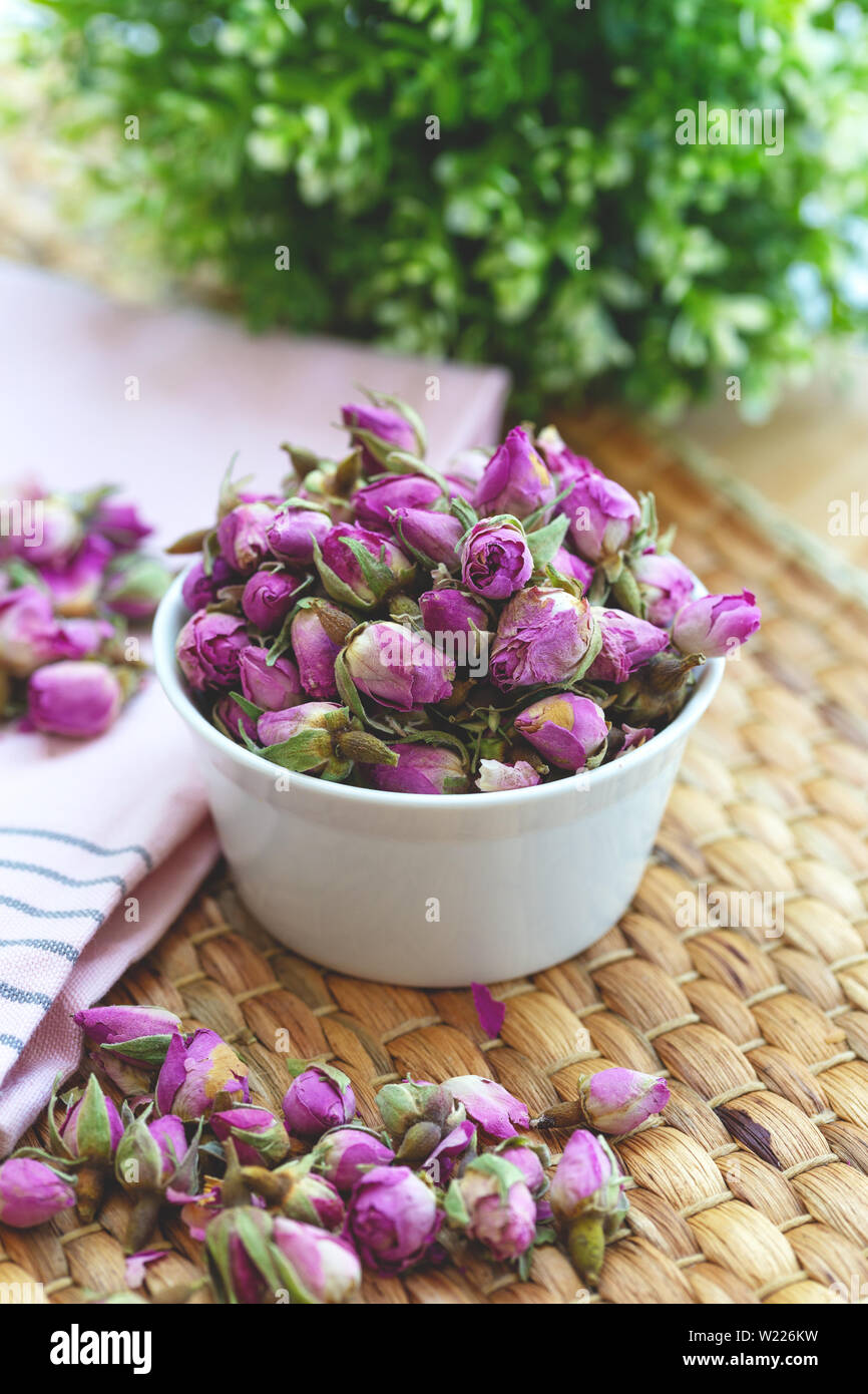 Dried pink roses tea in bowl Stock Photo - Alamy
