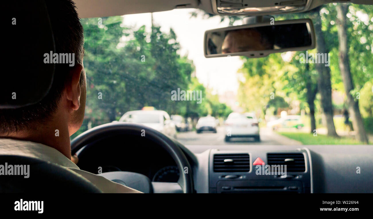 Man driving car from rear view on the city Stock Photo - Alamy