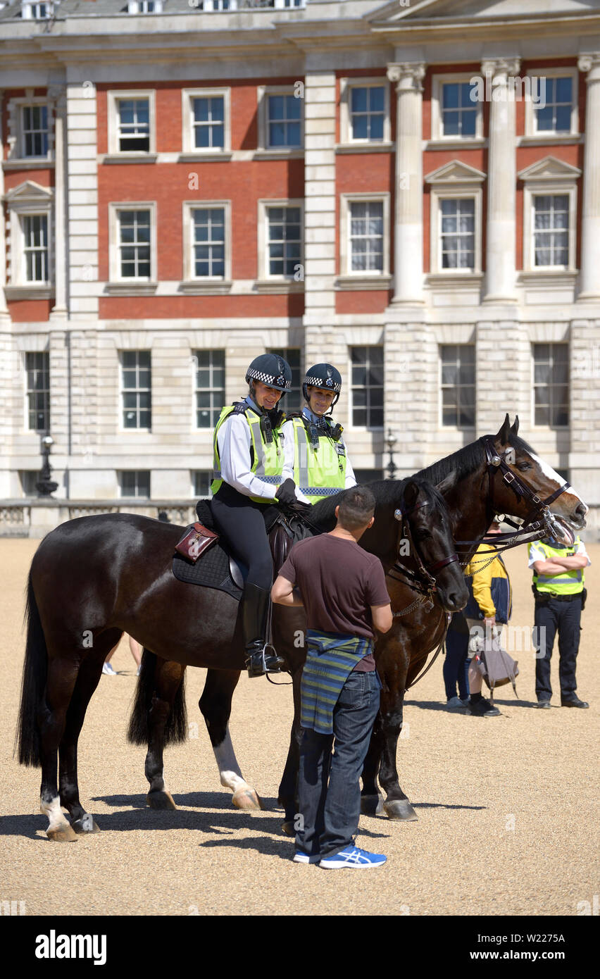 London, England, UK. Female mounted police officers talking to a ...
