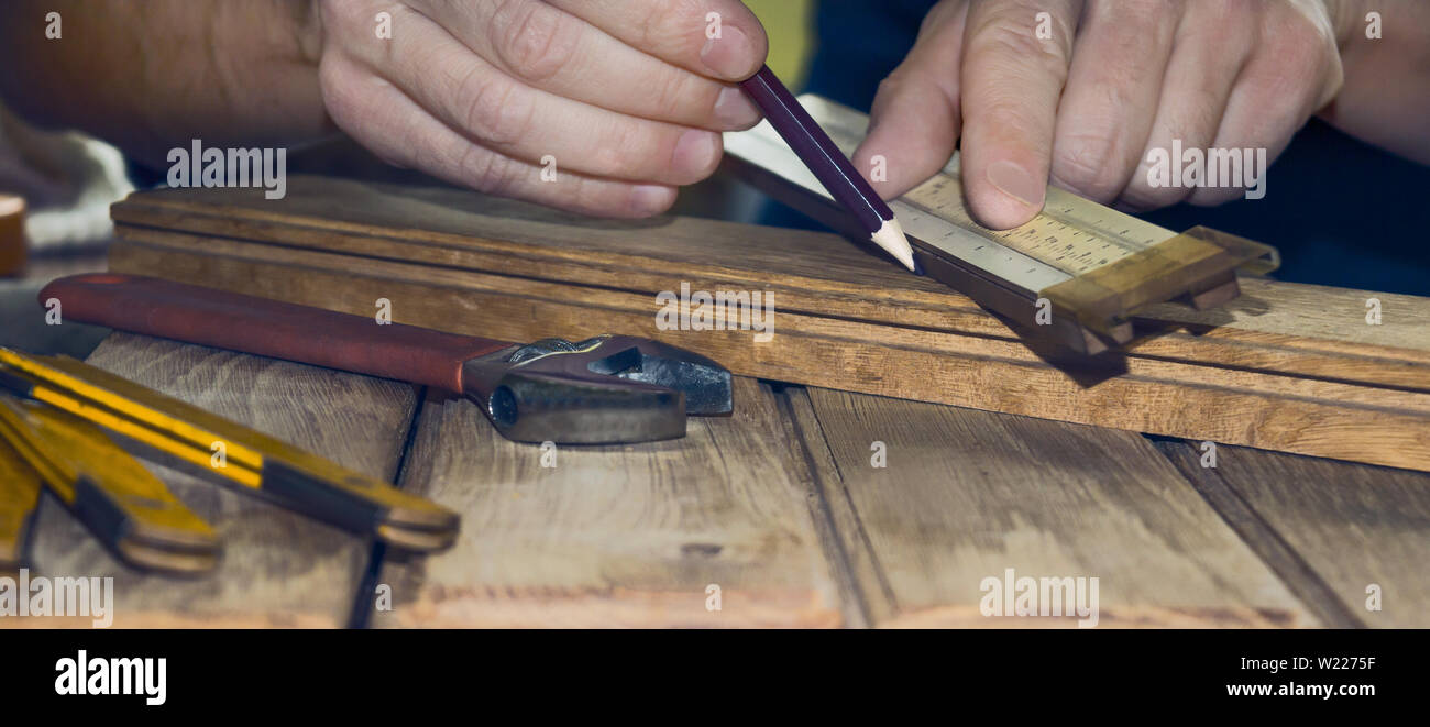 hand of a carpenter taking measurement of a wooden Stock Photo - Alamy