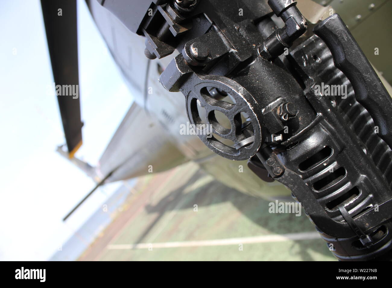 A detail from a machine gun mounted on the side of a helicopter. The ...
