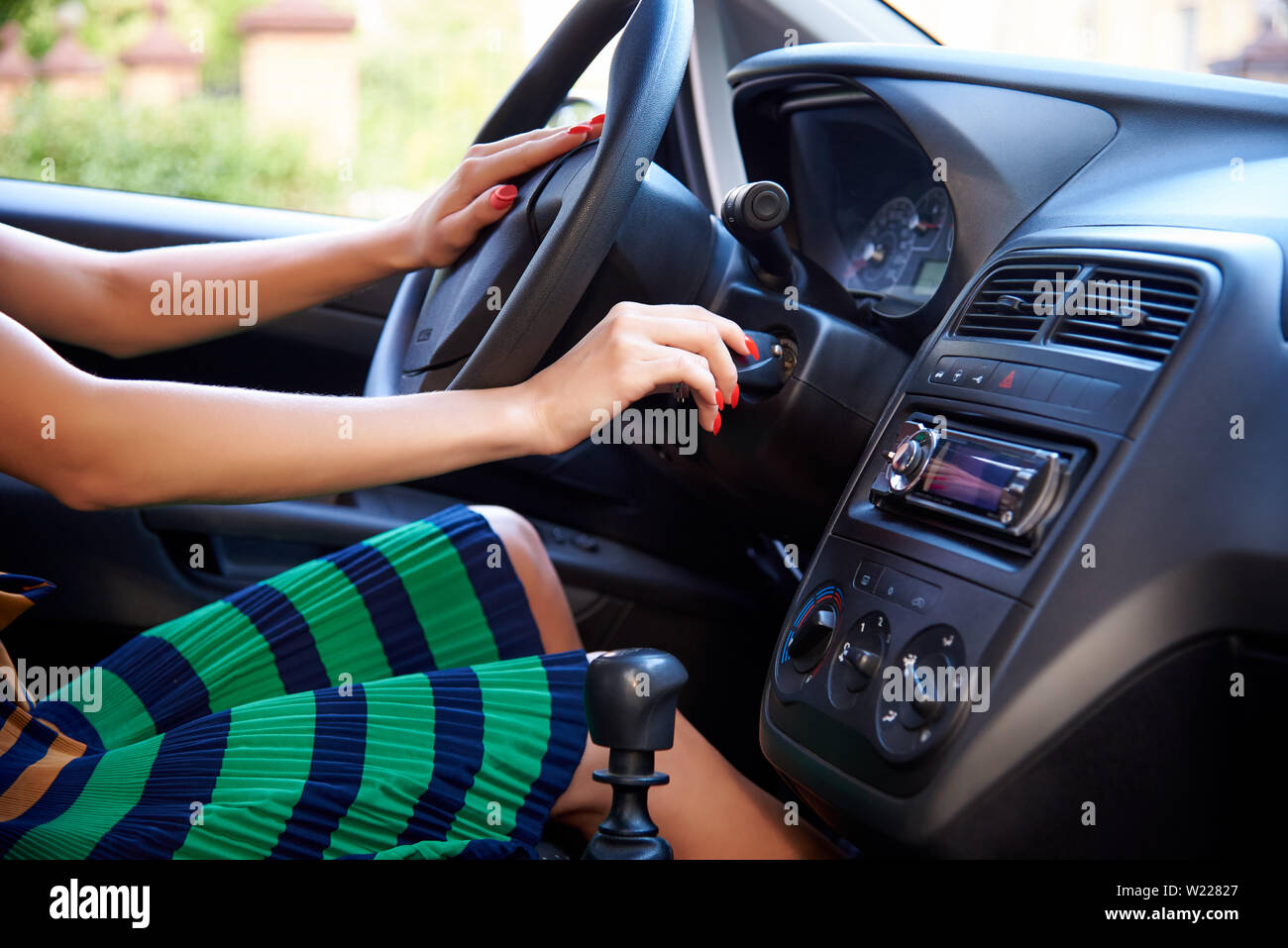 Young woman starts the car engine Stock Photo - Alamy