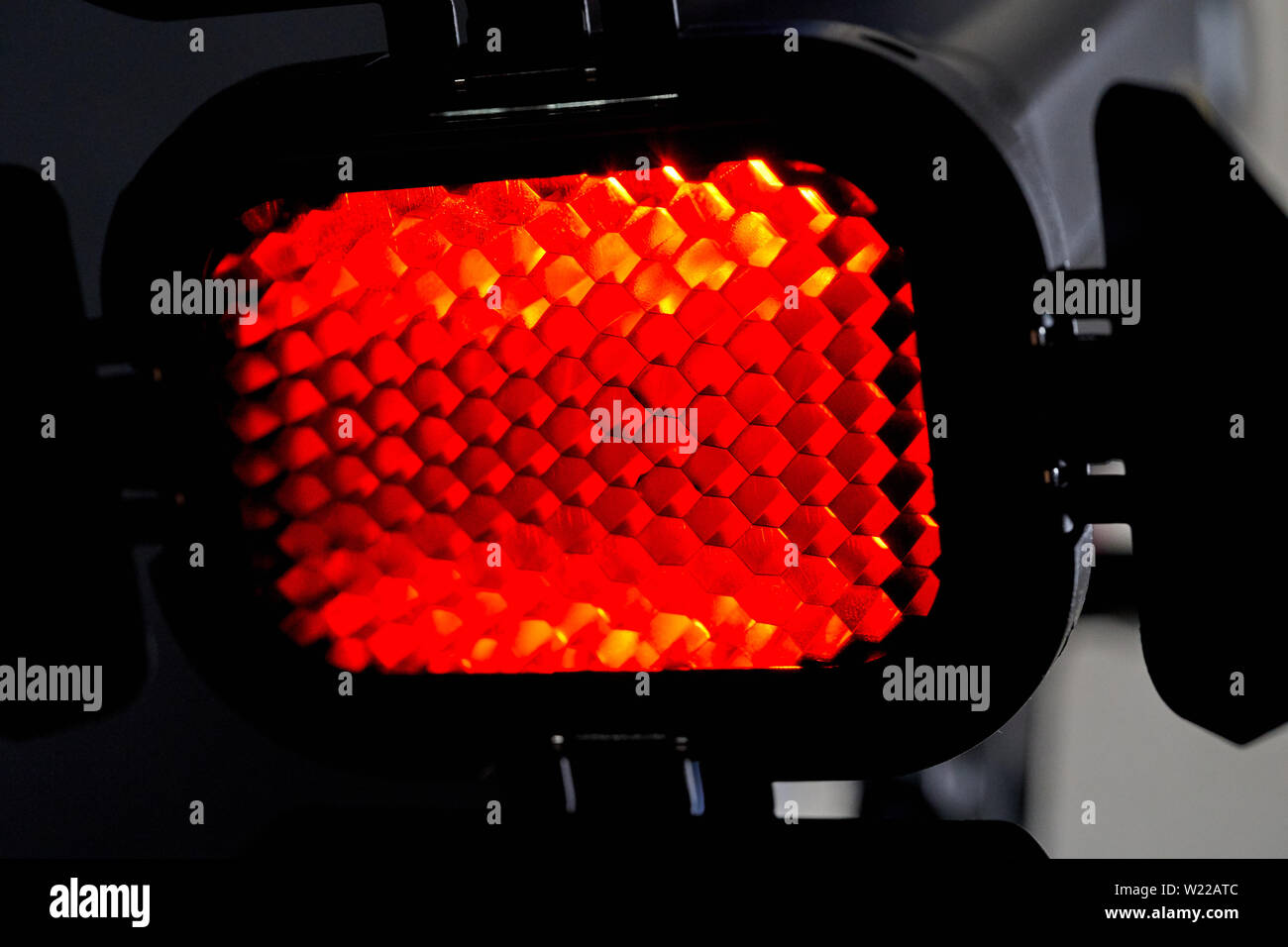 Spotlight with red light and honeycomb. Photo and video equipment for ...