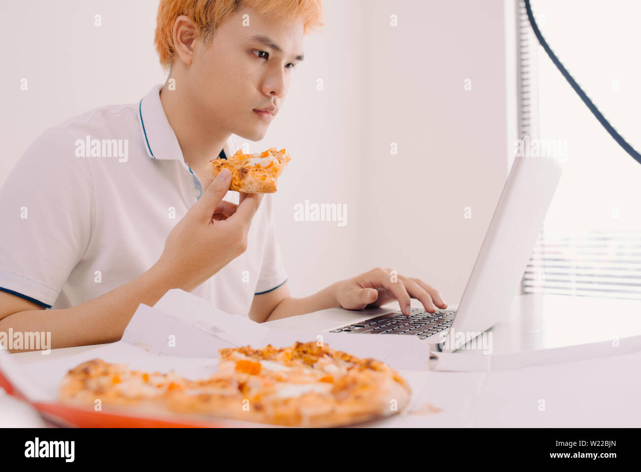 Happy man eating pizza night hi-res stock photography and images - Alamy