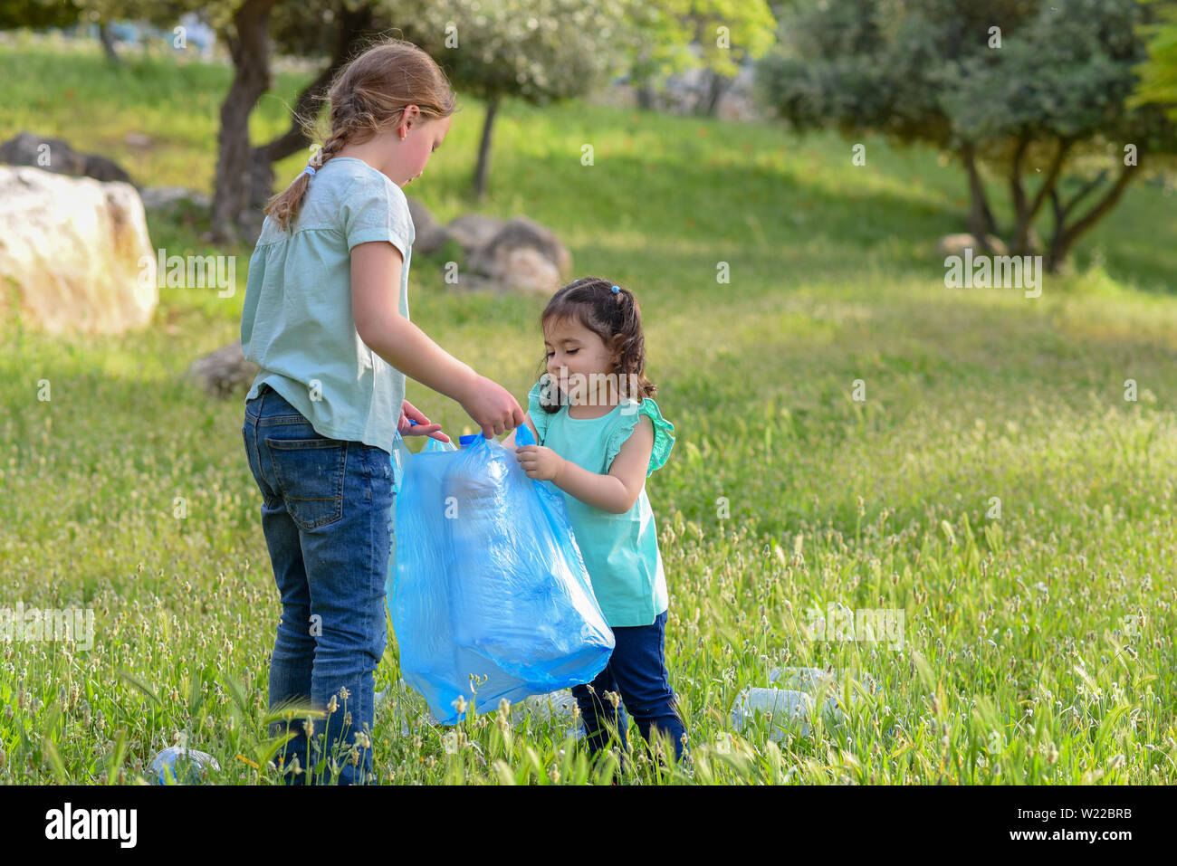 Plastic pollution on land. Polluted park, environmental rubish ...