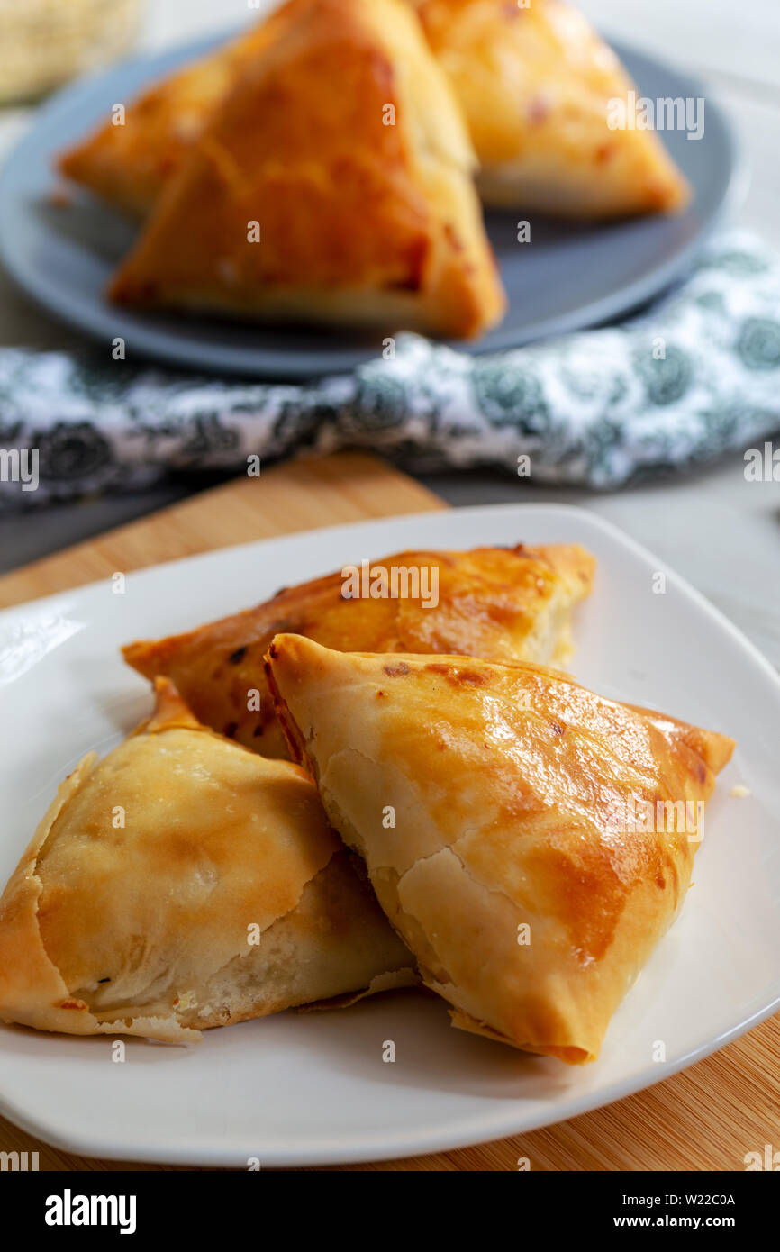 Puff pastry triangles filled minced meat, onion and spices Stock Photo ...