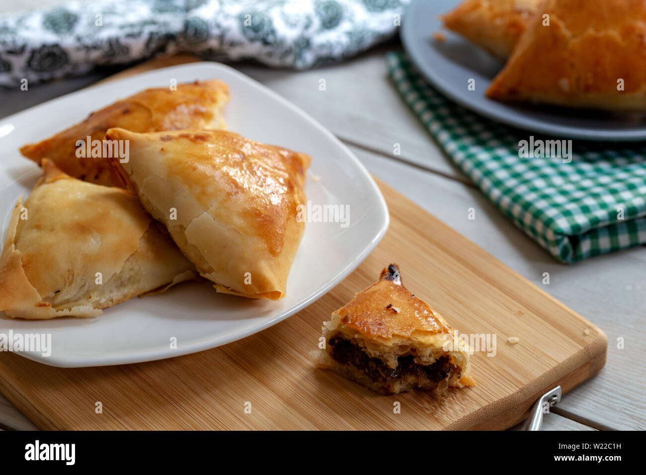 Puff pastry triangles filled minced meat, onion and spices Stock Photo ...